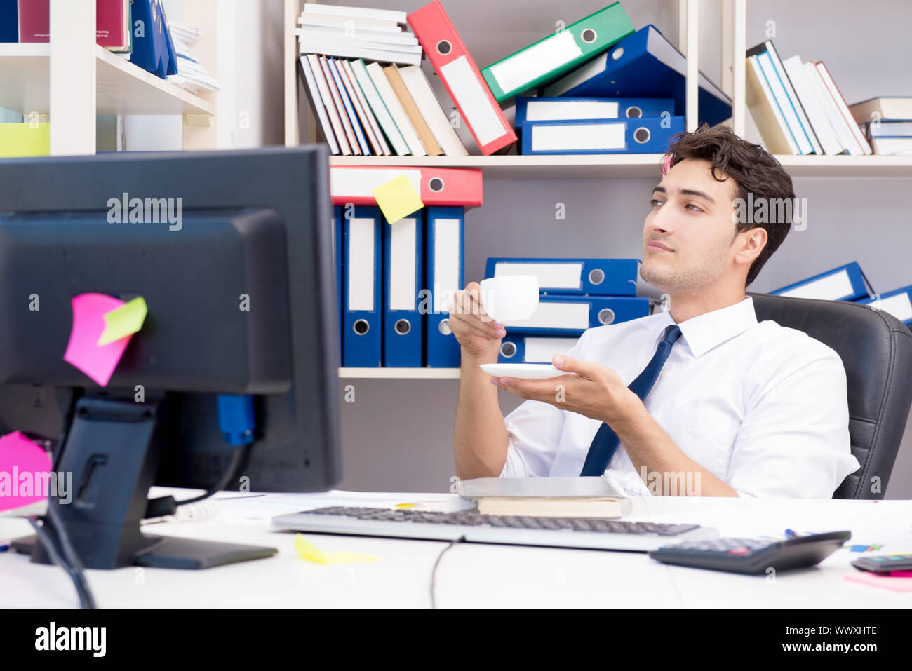 Businessman working in the office with piles of books and papers Stock ...