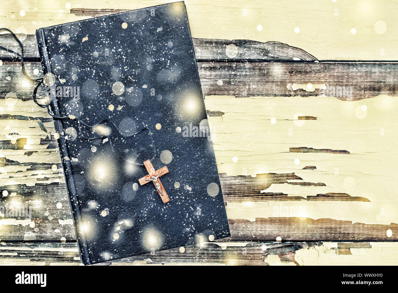 Christmas. Bible and cross on a white background old. Falling ...