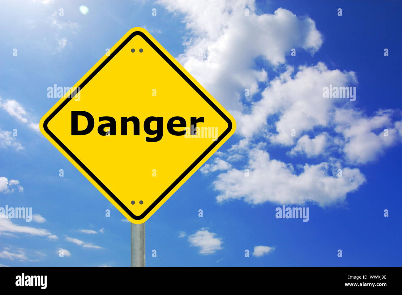 danger written on a yellow road warning sign Stock Photo - Alamy
