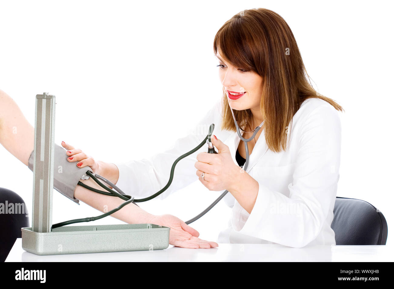 Female nurse measuring patient's blood pressure, with right hand ...