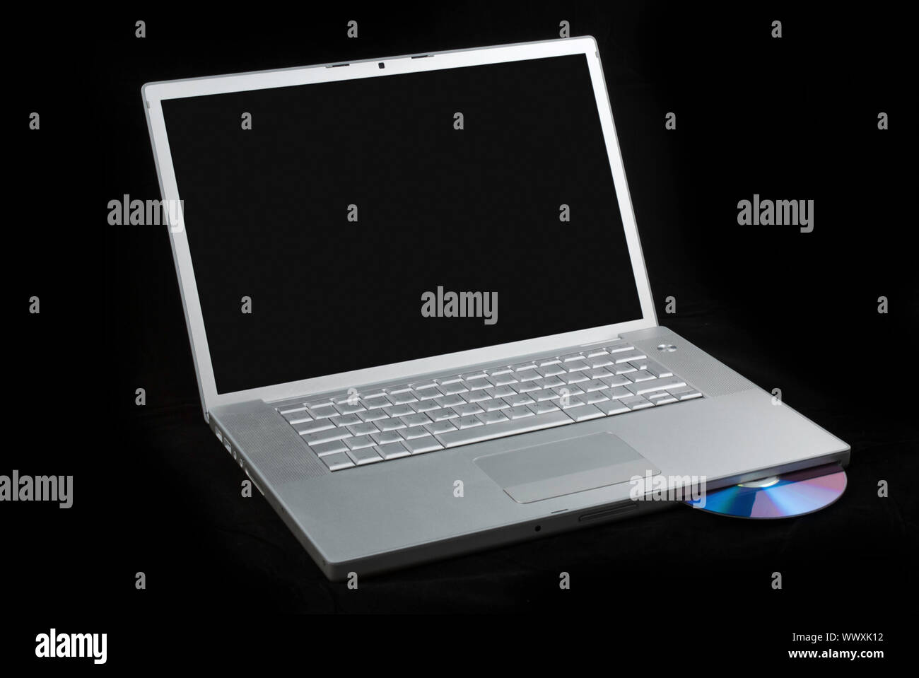 Silver portable computer with CD inserted. 3/4 view Stock Photo - Alamy