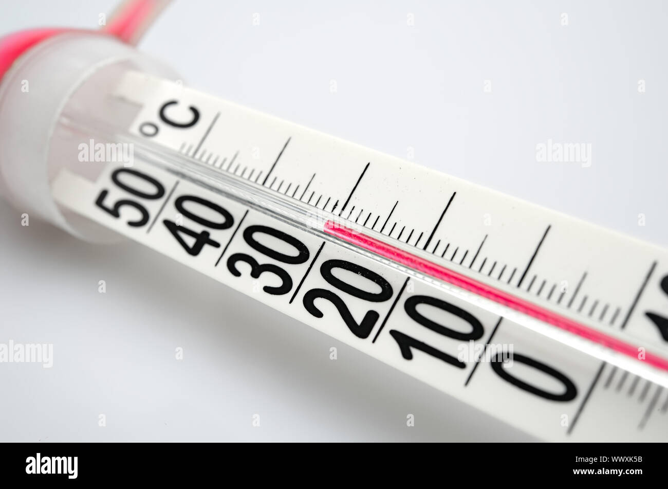 Closeup of celsius thermometer showing heat readings. Isolated against ...