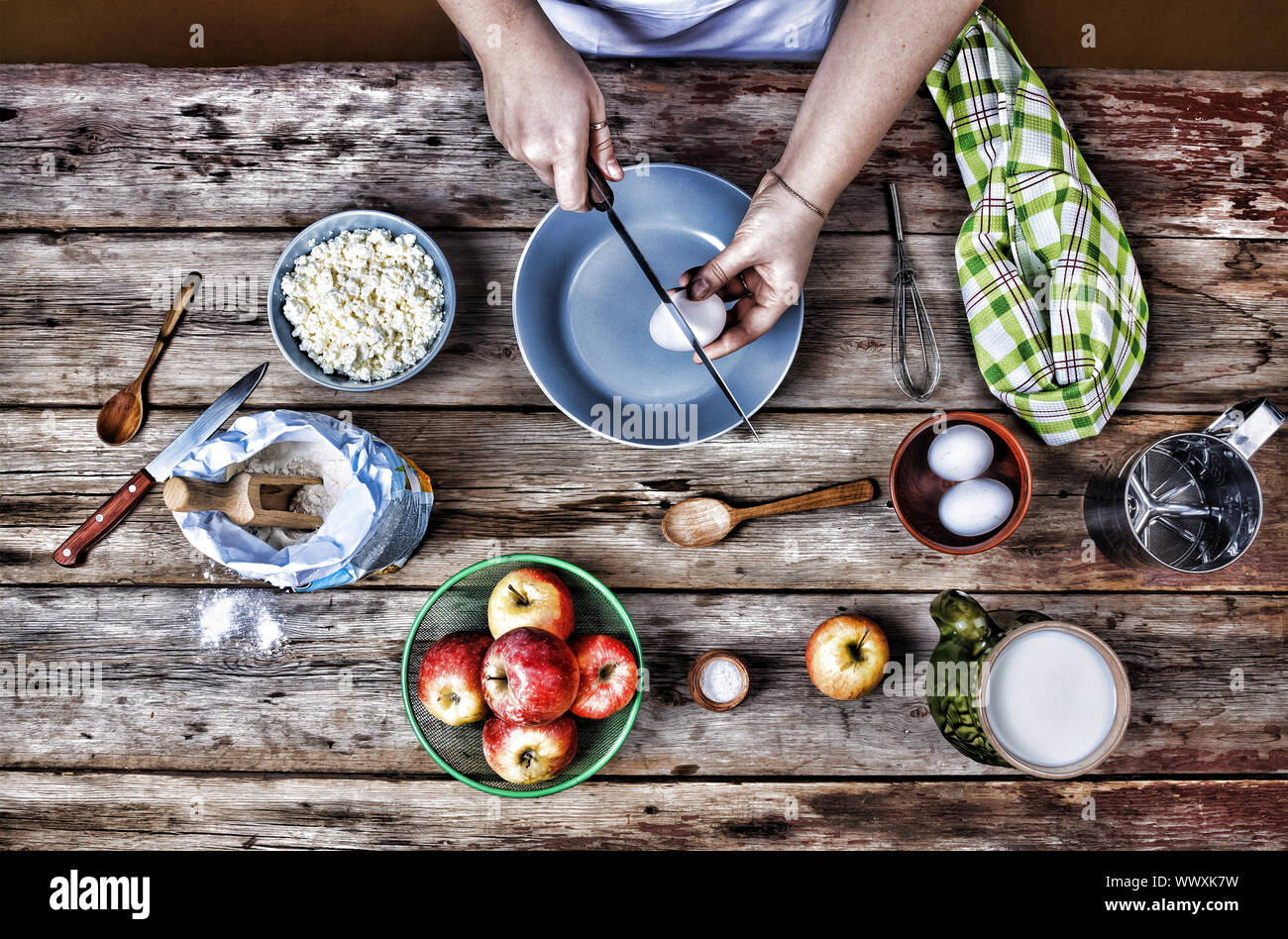 Cooking food. Woman cook breaks egg dough Stock Photo - Alamy