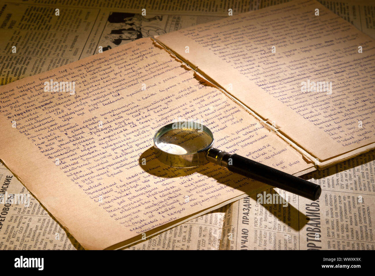 Magnifier glass on page of ancient manuscript, old newspaper. Small ...