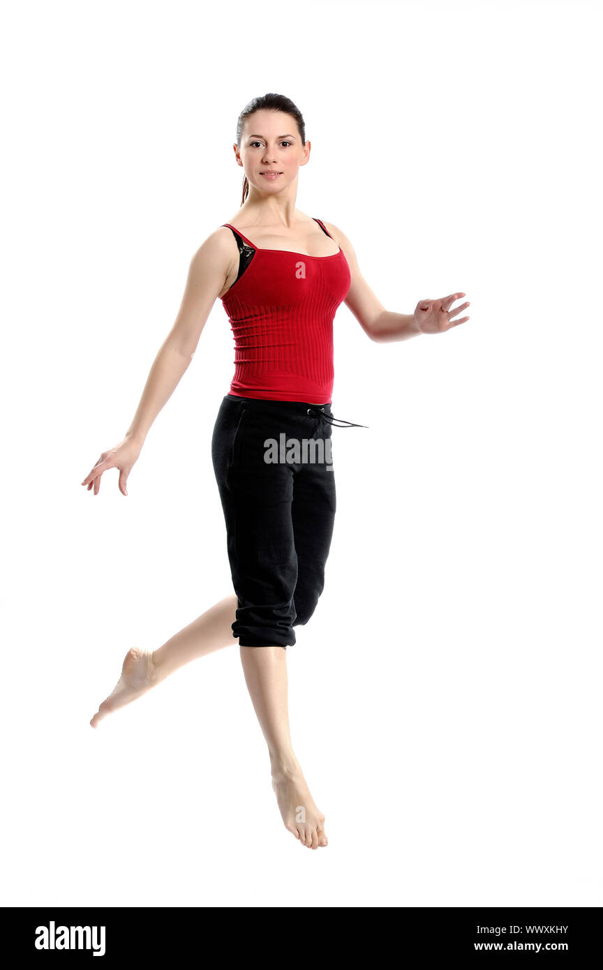 Girl in sportswear jumping jumping over white background. Isolated ...
