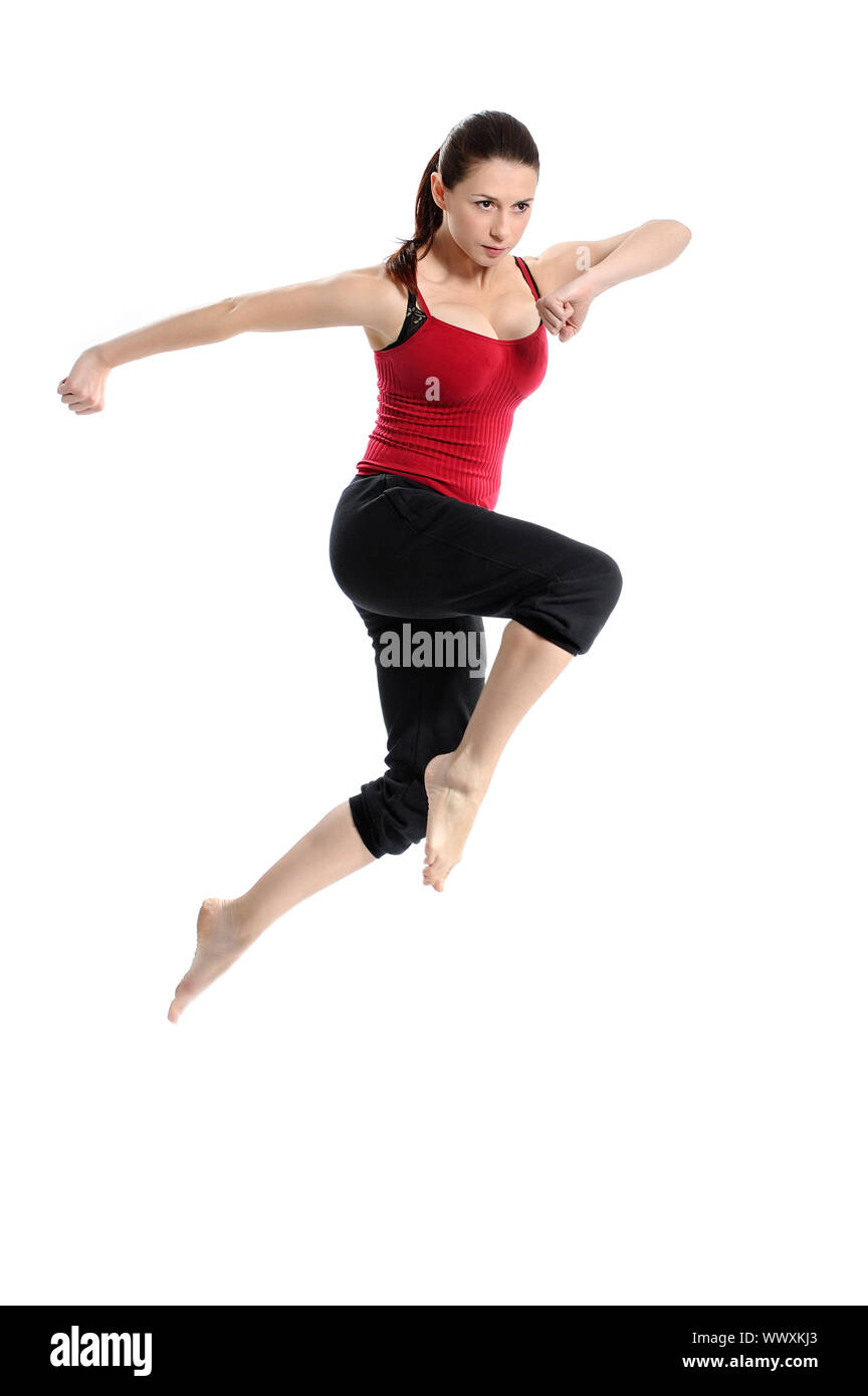 Girl in sportswear jumping jumping over white background. Isolated ...