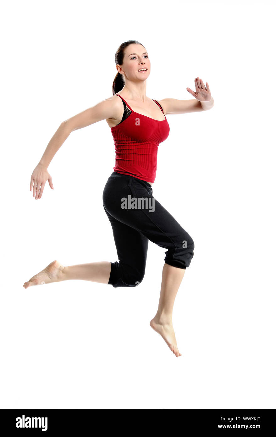 Girl in sportswear jumping jumping over white background. Isolated ...