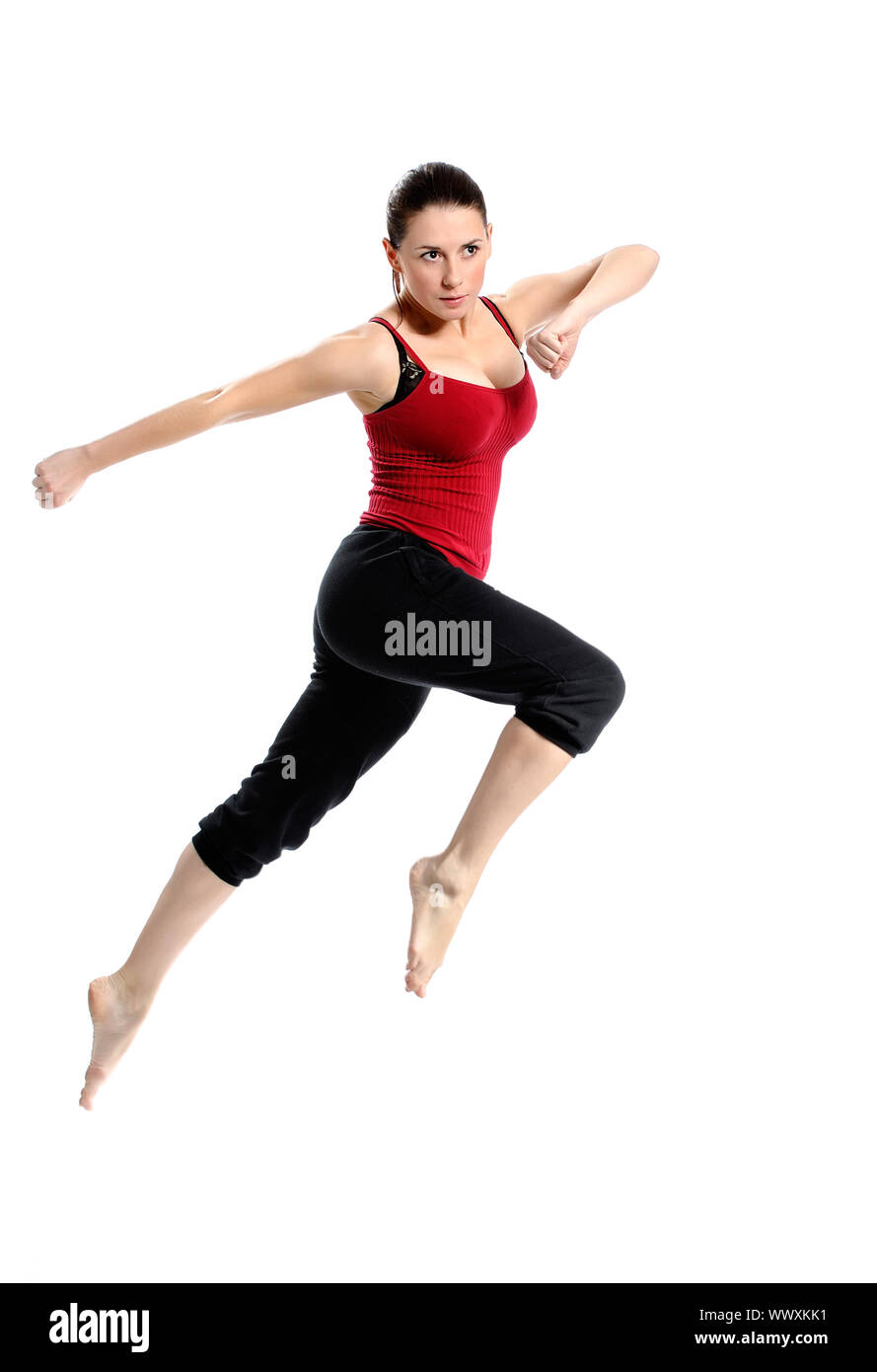 Girl in sportswear jumping jumping over white background. Isolated ...