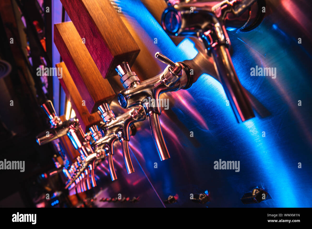 Beer pouring machine in nightclub or bar. Bright and modern neon light ...