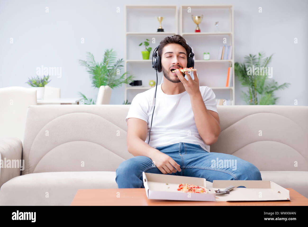The man eating pizza having a takeaway at home relaxing resting Stock ...