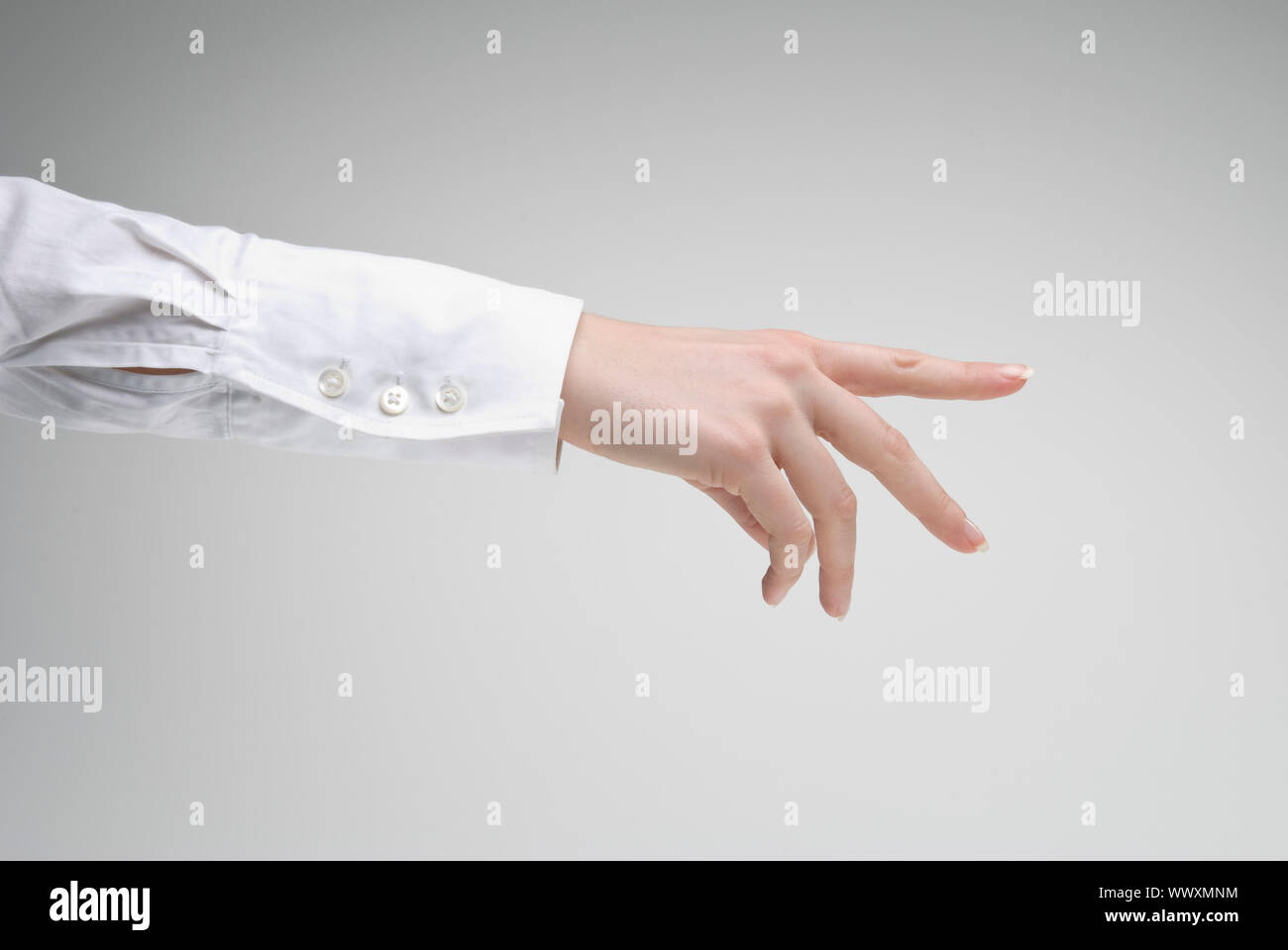 Woman extends a hand over light background Stock Photo - Alamy