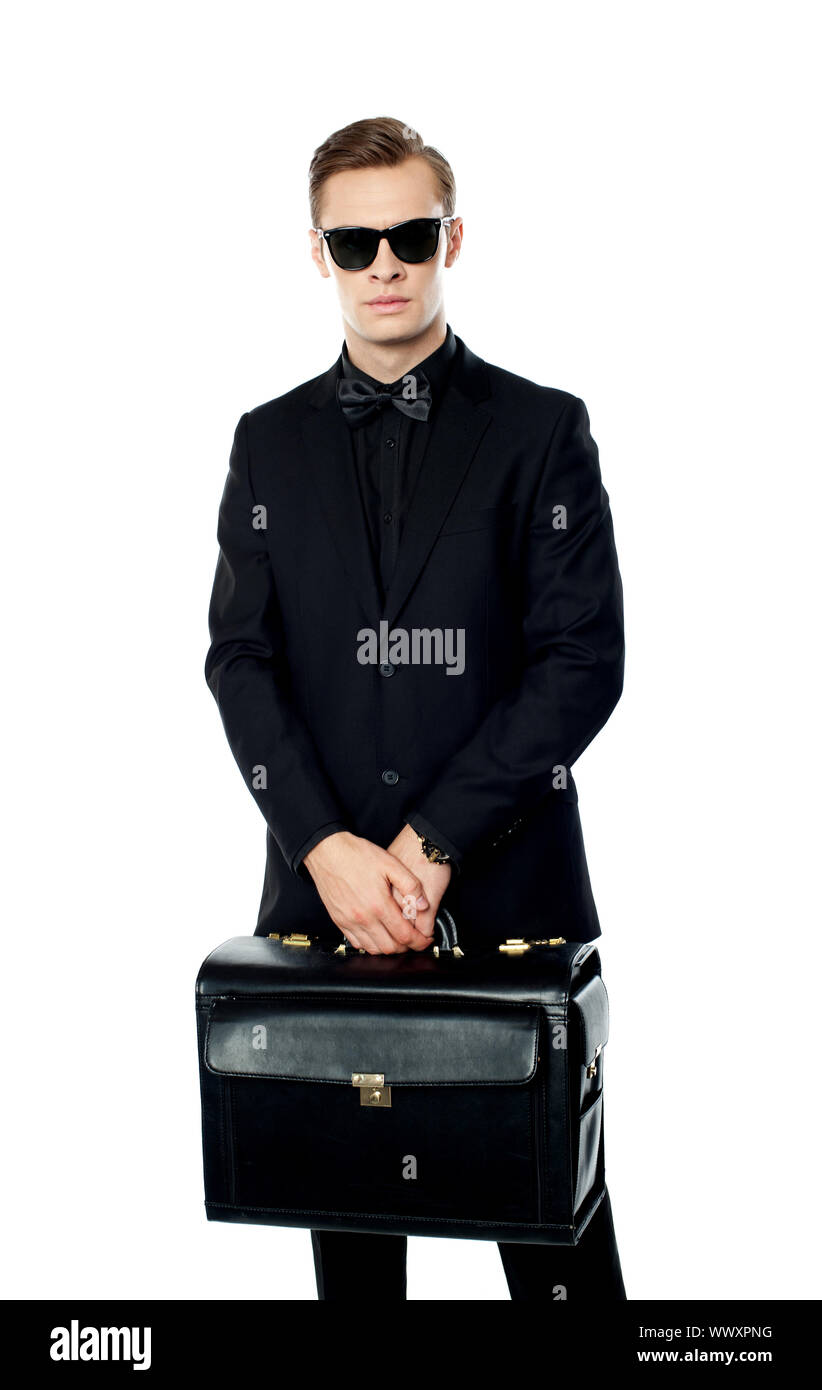 Young man carrying briefcase and wearing sunglasses Stock Photo - Alamy