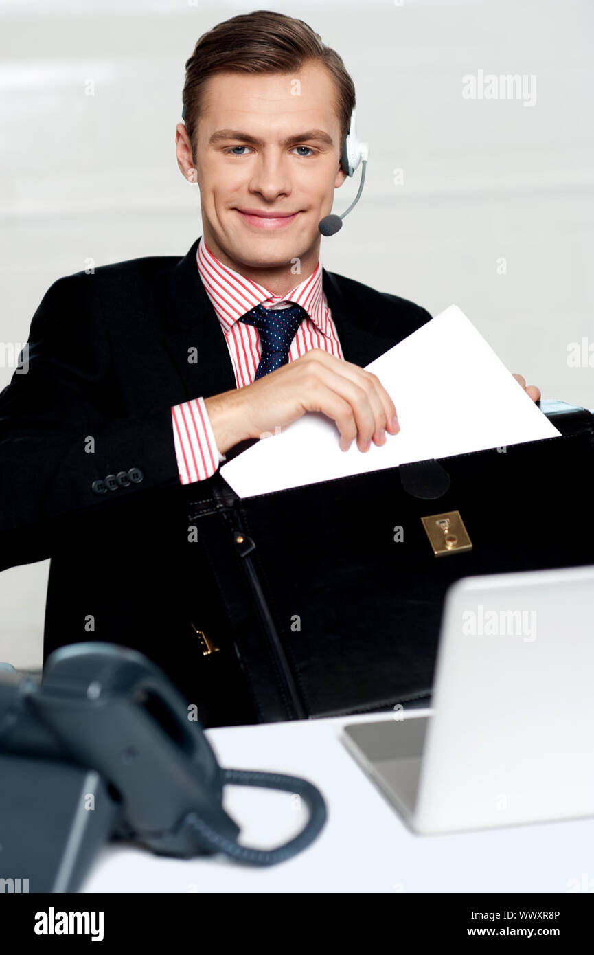 Customer care person arranging office documents. Sitting in office ...