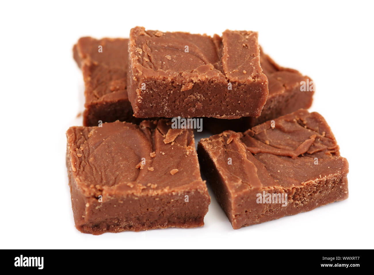 Small pile of homemade chocolate fudge pieces on a white background ...