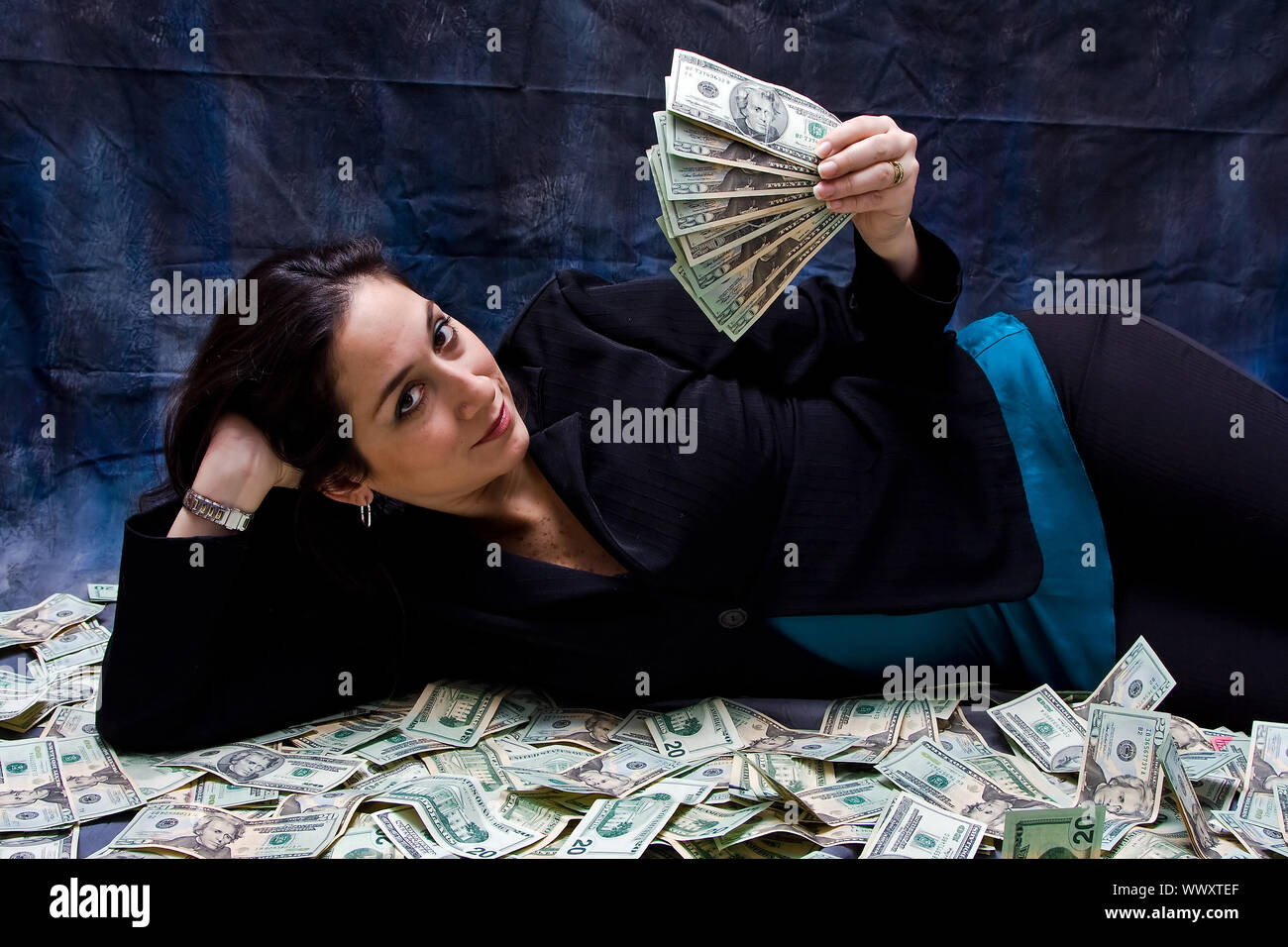 Rich business woman waving money and laying with her money isolated on ...
