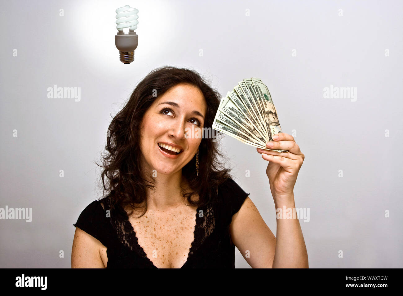 Woman with a money saving idea Stock Photo - Alamy