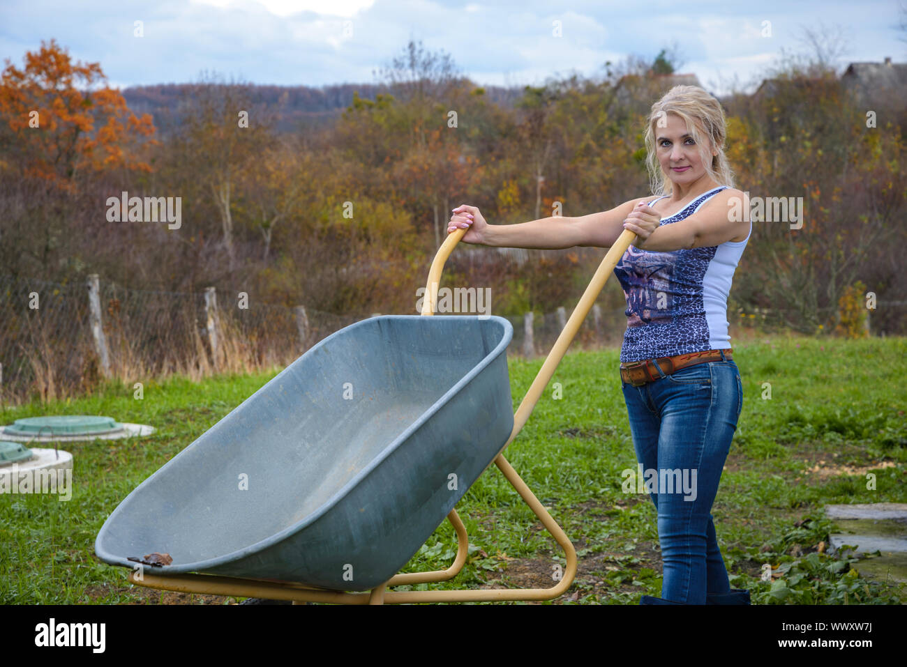 Blonde with a wheelbarrow Stock Photo - Alamy