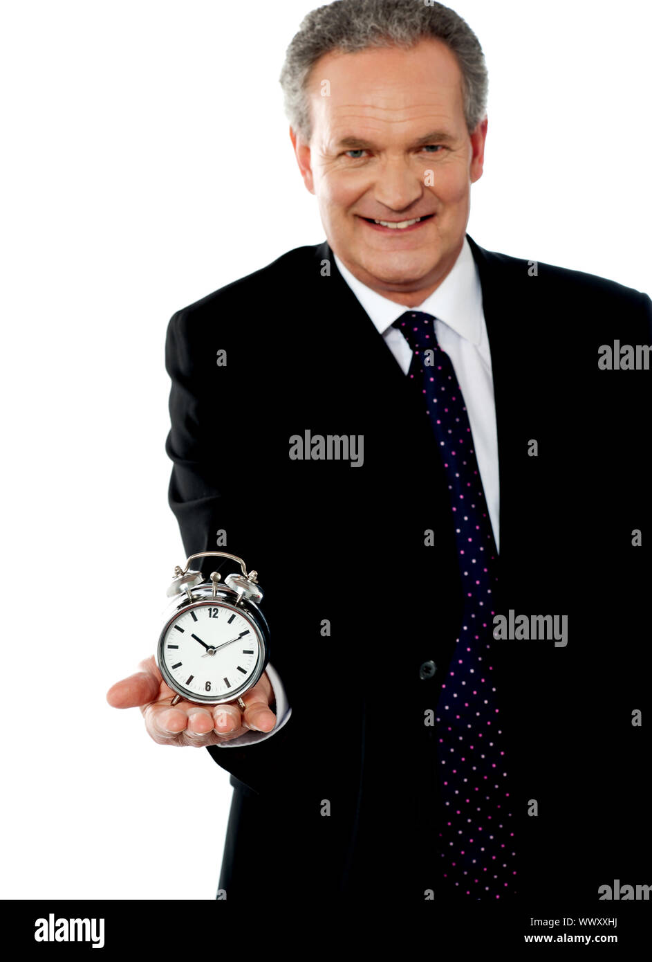 Corporate man showing alarm clock isolated over white background Stock ...
