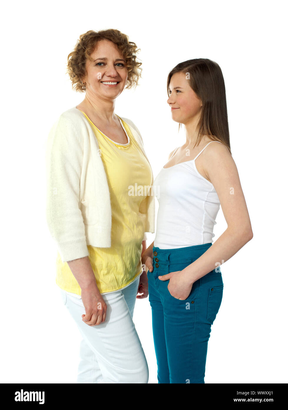 Pretty teenage girl looking at her modern mum. All on white background ...