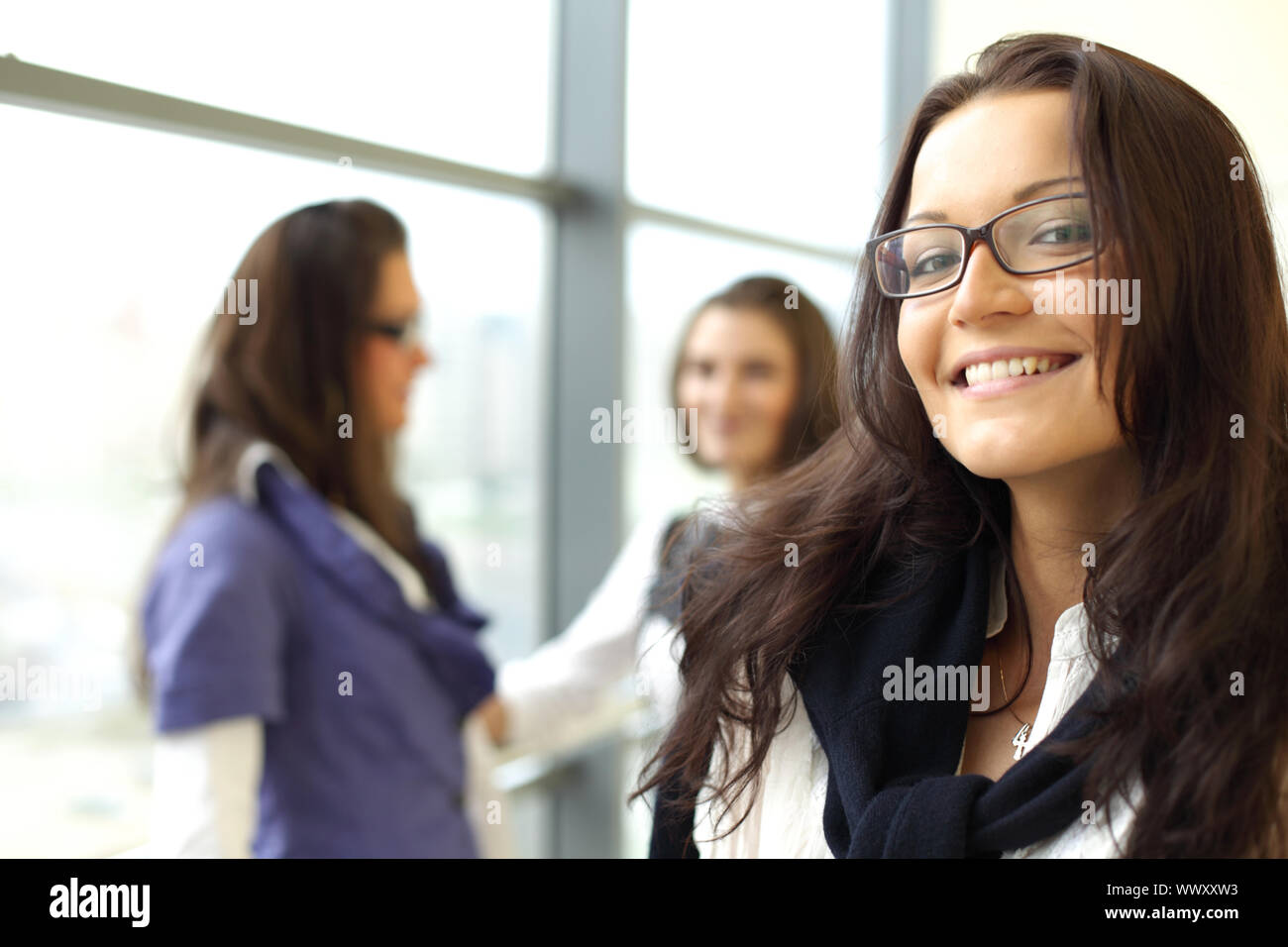 Student meeting smiley girl face on foreground Stock Photo - Alamy