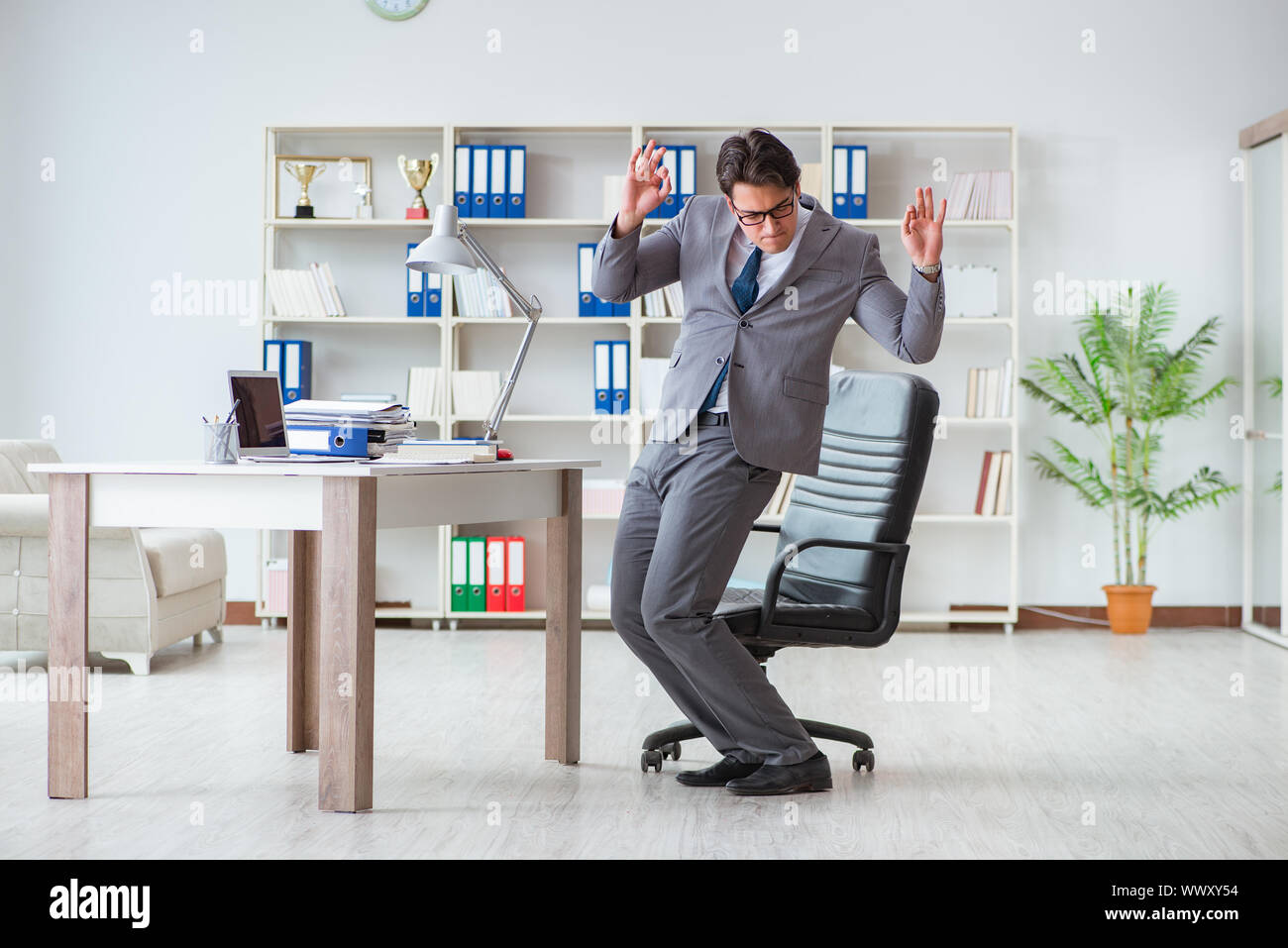 Businessman having fun taking a break in the office at work Stock Photo ...