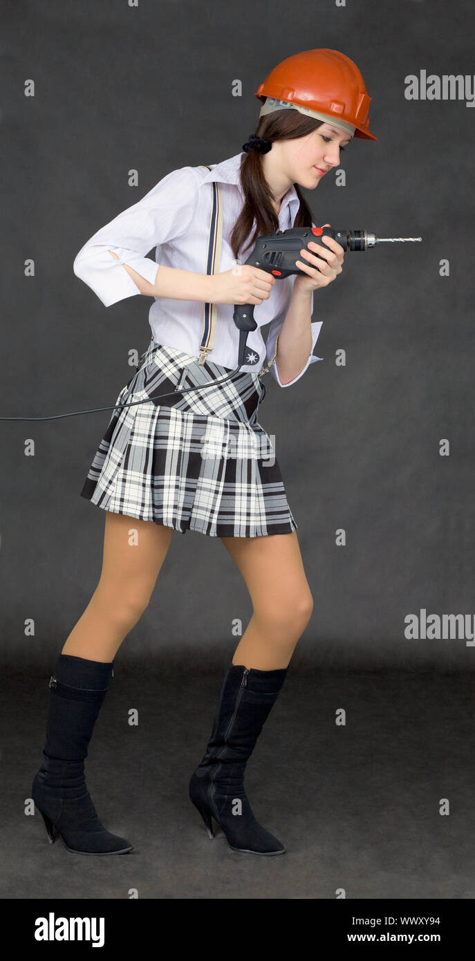 Female student learns to use power tools on black background Stock ...