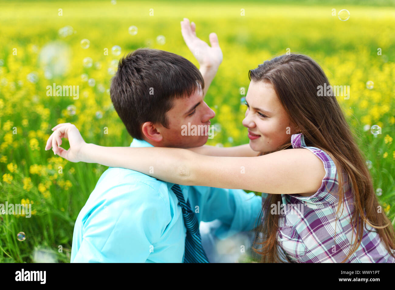 lovers hug on yellow flower field Stock Photo - Alamy