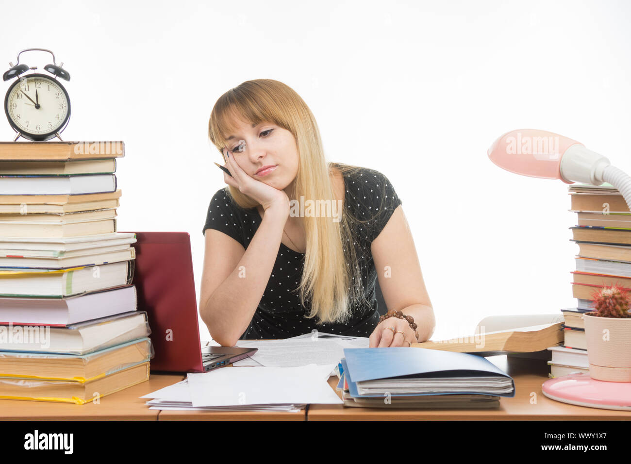 Student tired of looking at the laptop at the desk in the library ...