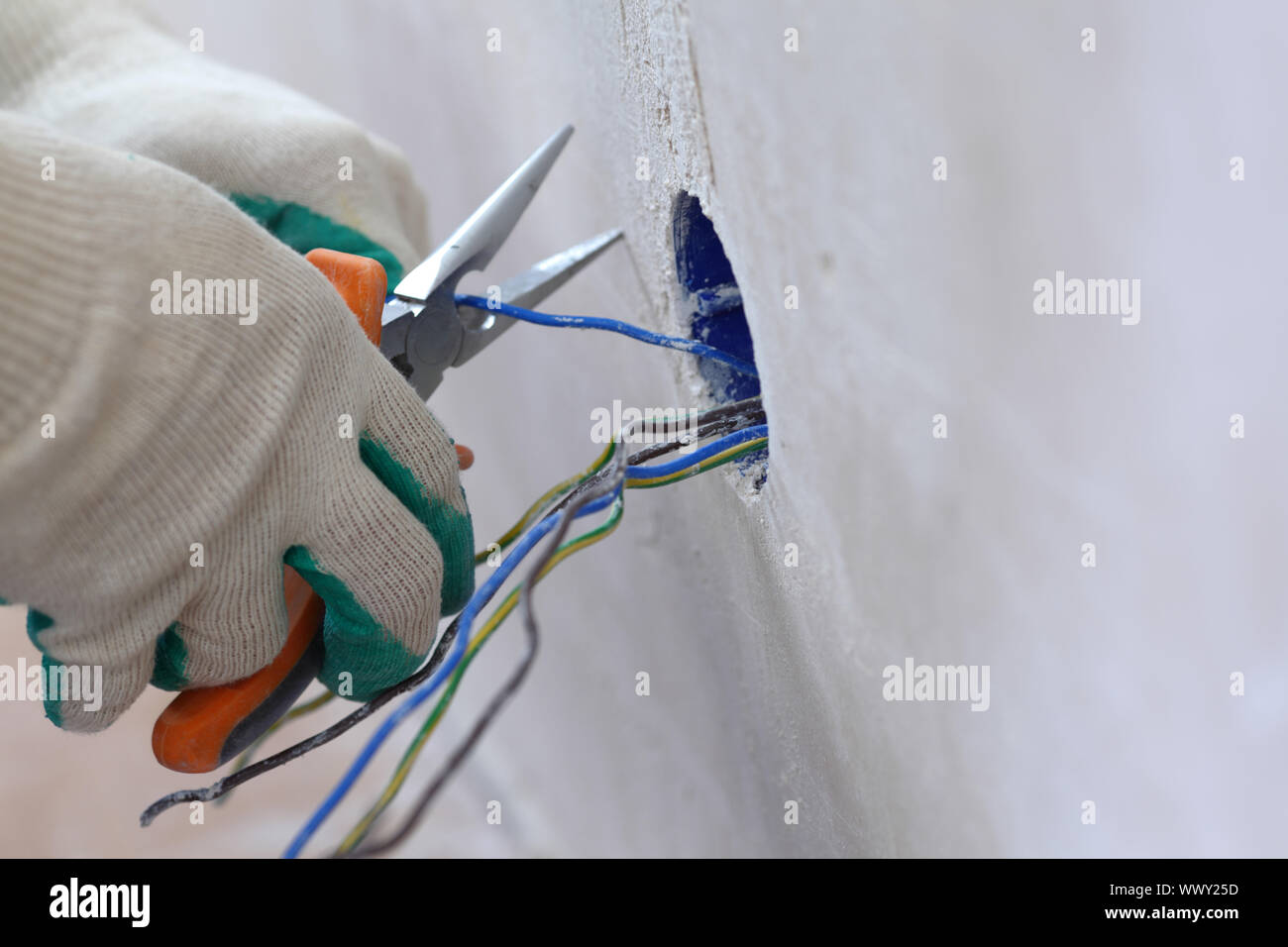 worker puts the wires in the wall Stock Photo - Alamy