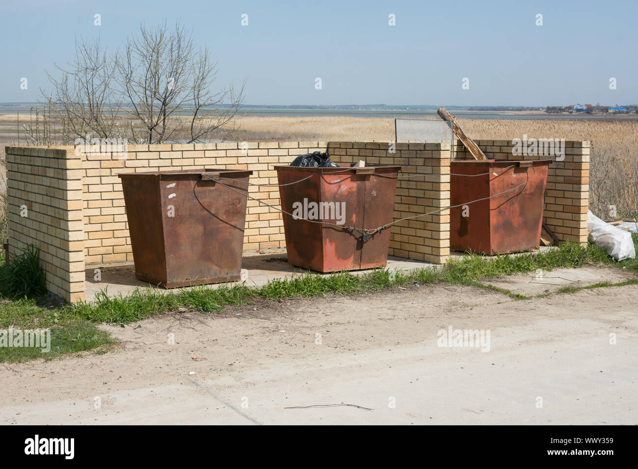 Three garbage tank linked metal cable are at the designated place and ...