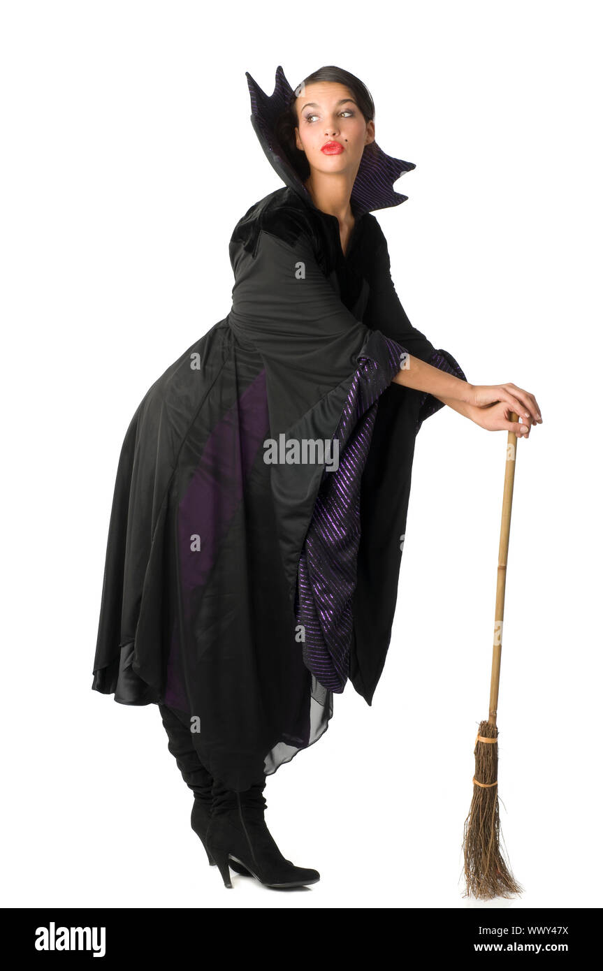 nice witch in black taking pose using a broom as a walking stick Stock ...