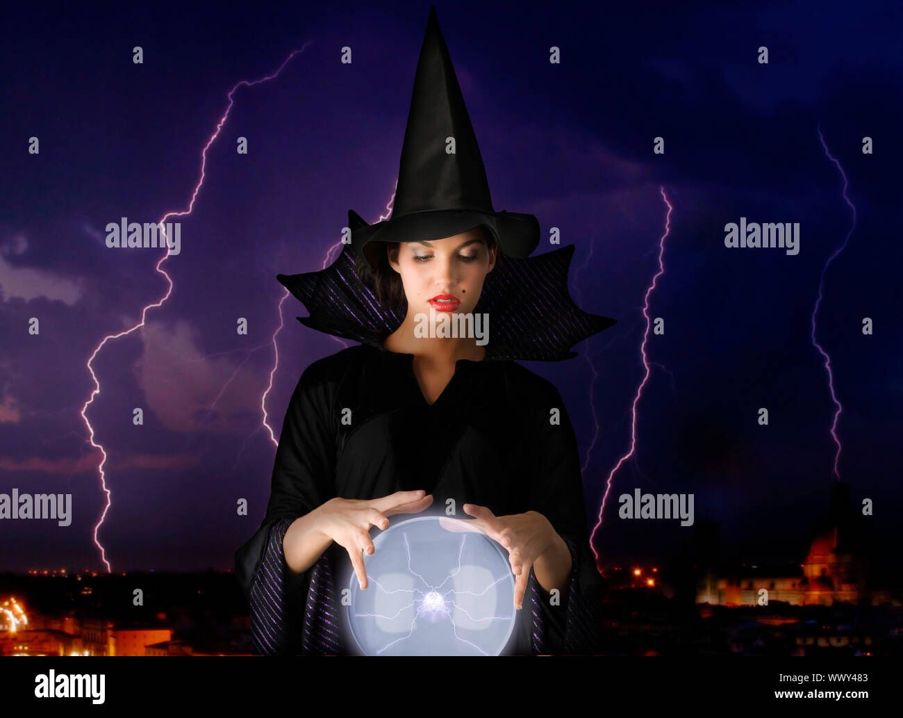 witch with magic crystal ball and lightning in background Stock Photo ...