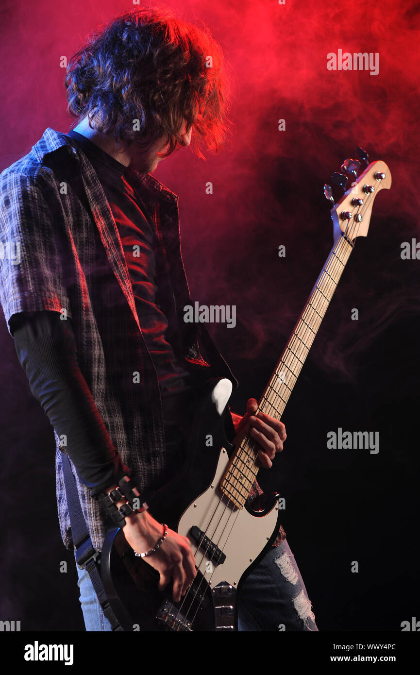 a bassist plays at a live concert Stock Photo - Alamy