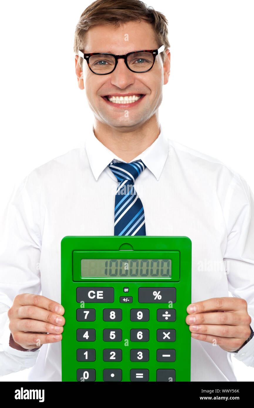 Smiling corporate man showing big green calculator against white ...