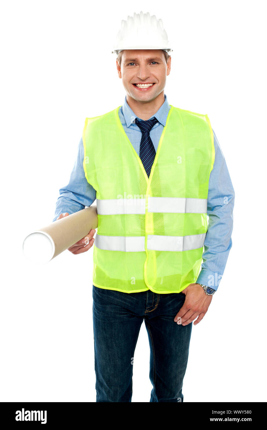 Smiling young architect holding blueprints wearing helmet and safety ... Smiling young architect holding blueprints wearing helmet and safety ...