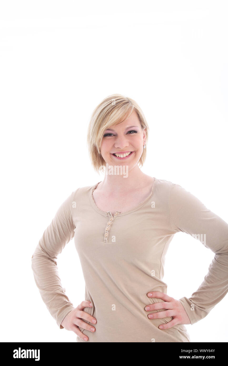 Smiling blonde woman with her hands on her hips isolated on white Stock ...