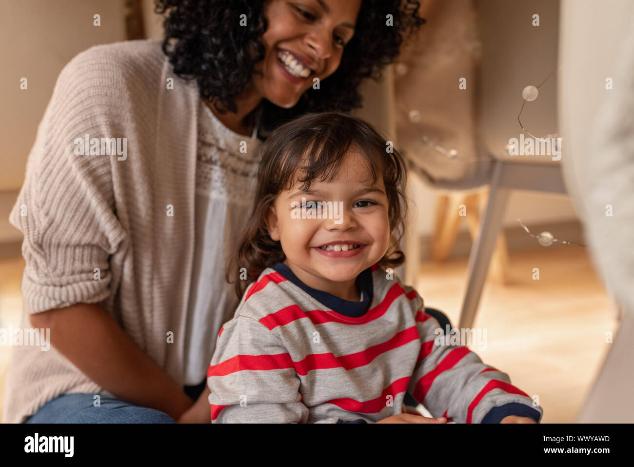 Little girl playing with her mother in a blanket fort Stock Photo - Alamy