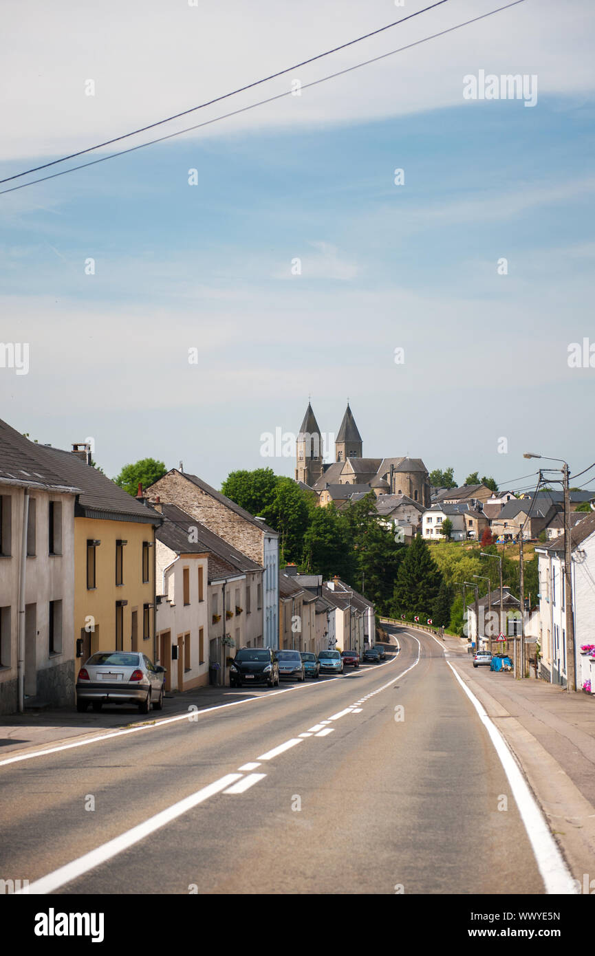 Main street in village Habay with cars and church Stock Photo - Alamy