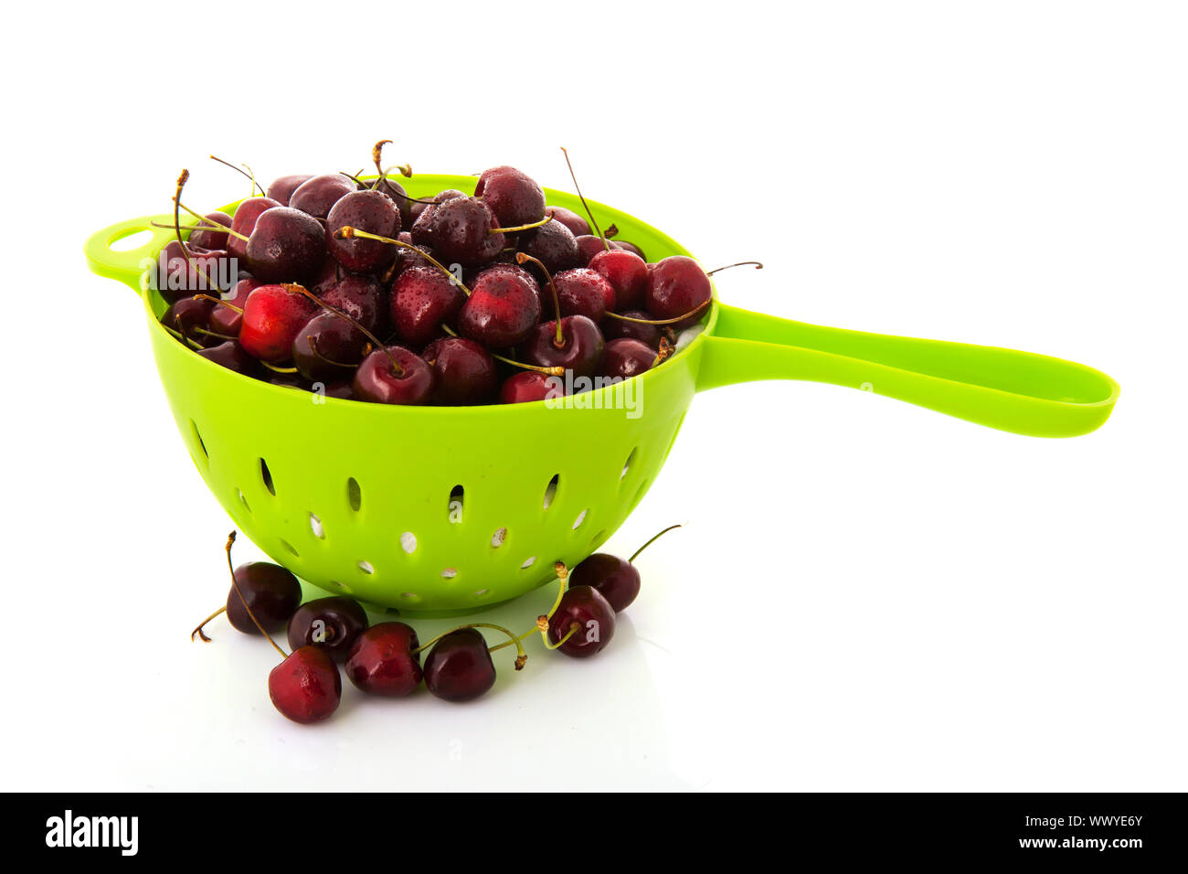 Washing cherries in green strainer Stock Photo - Alamy