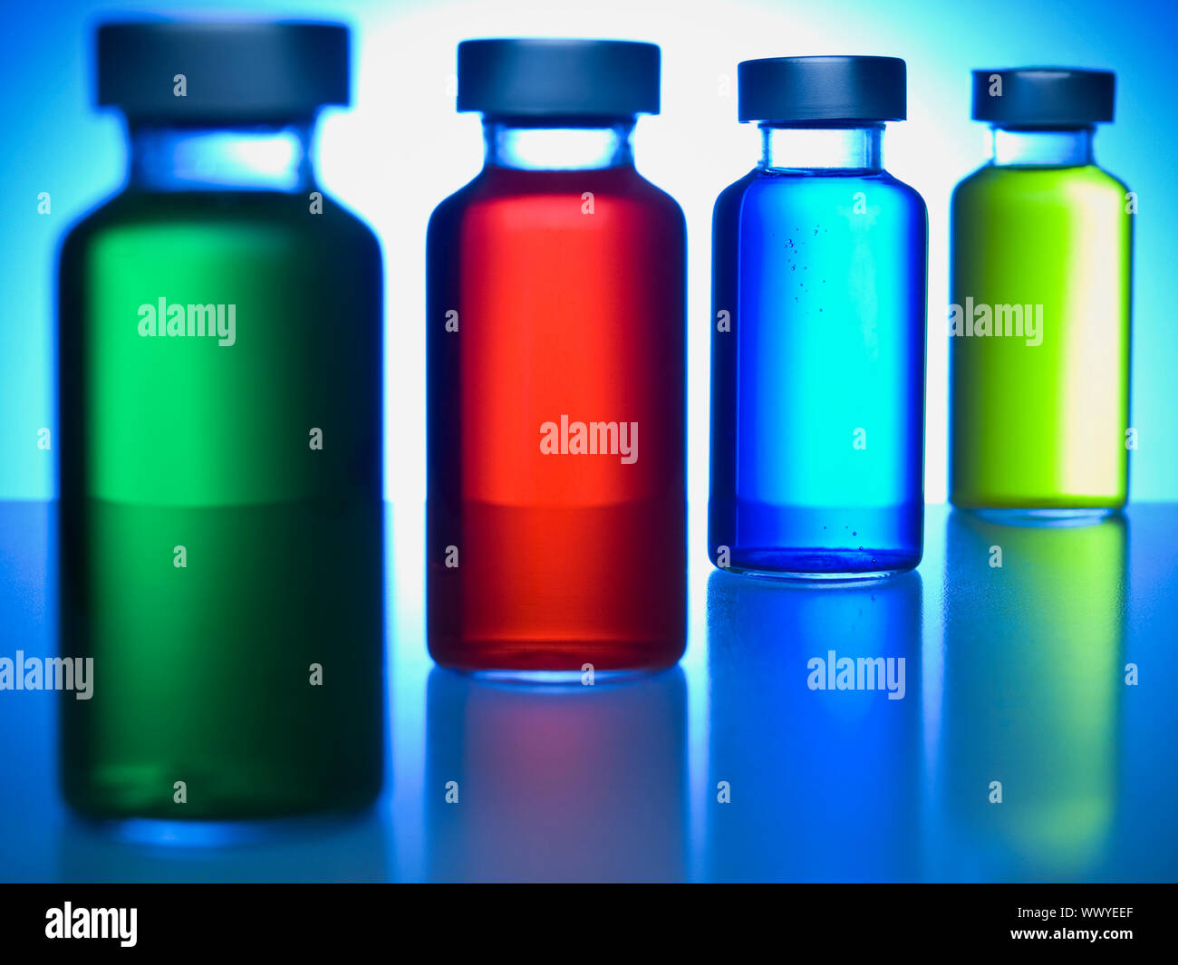 A row of vials filled with colored liquids. Focus on the blue one Stock ...