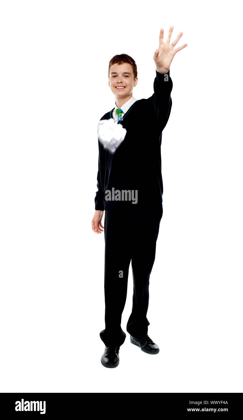Cheerful young boy throwing paper isolated over white Stock Photo - Alamy