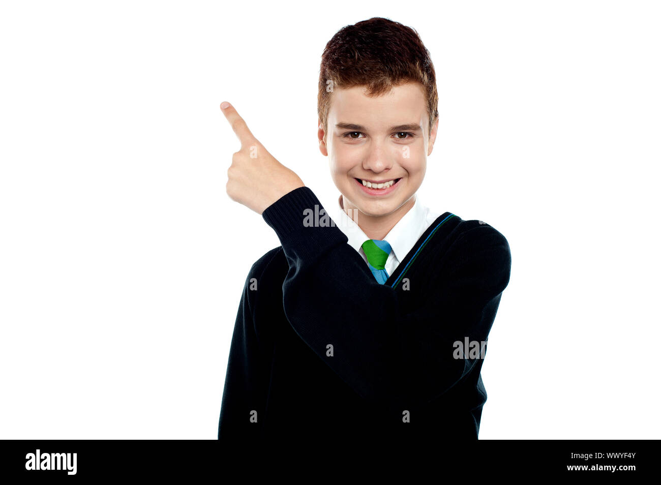 Happy young boy indicating upwards and smiling at camera Stock Photo ...