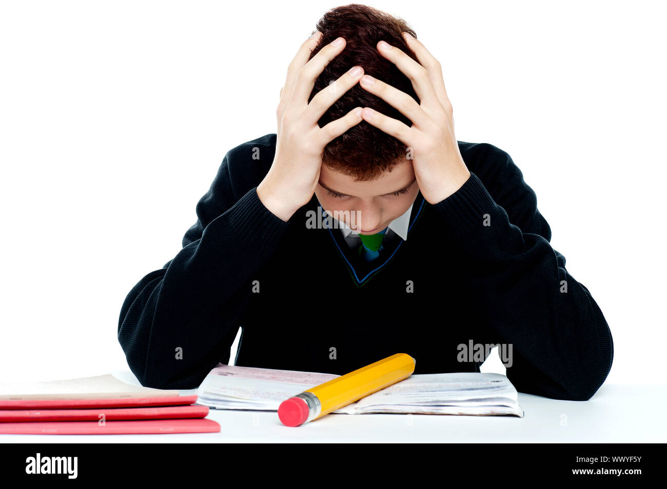 Confused student holding his head in classroom. All on white background ...