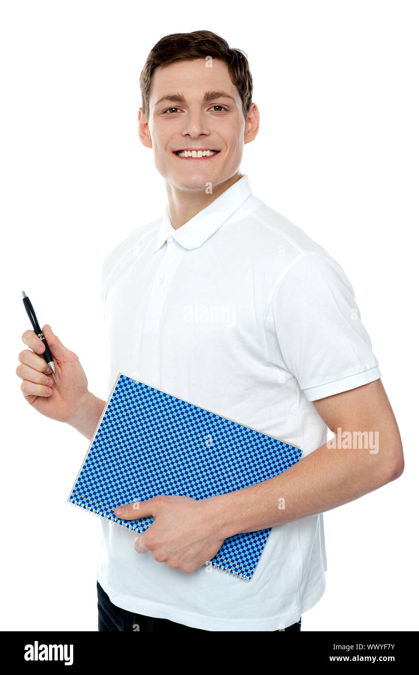 Smiling young man with notepad and pen against white background Stock ...