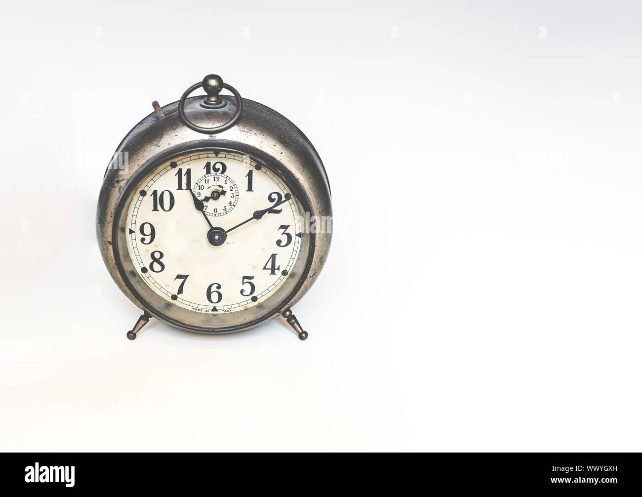 old analog clock with hands and numbers. Analog metal alarm clock ...