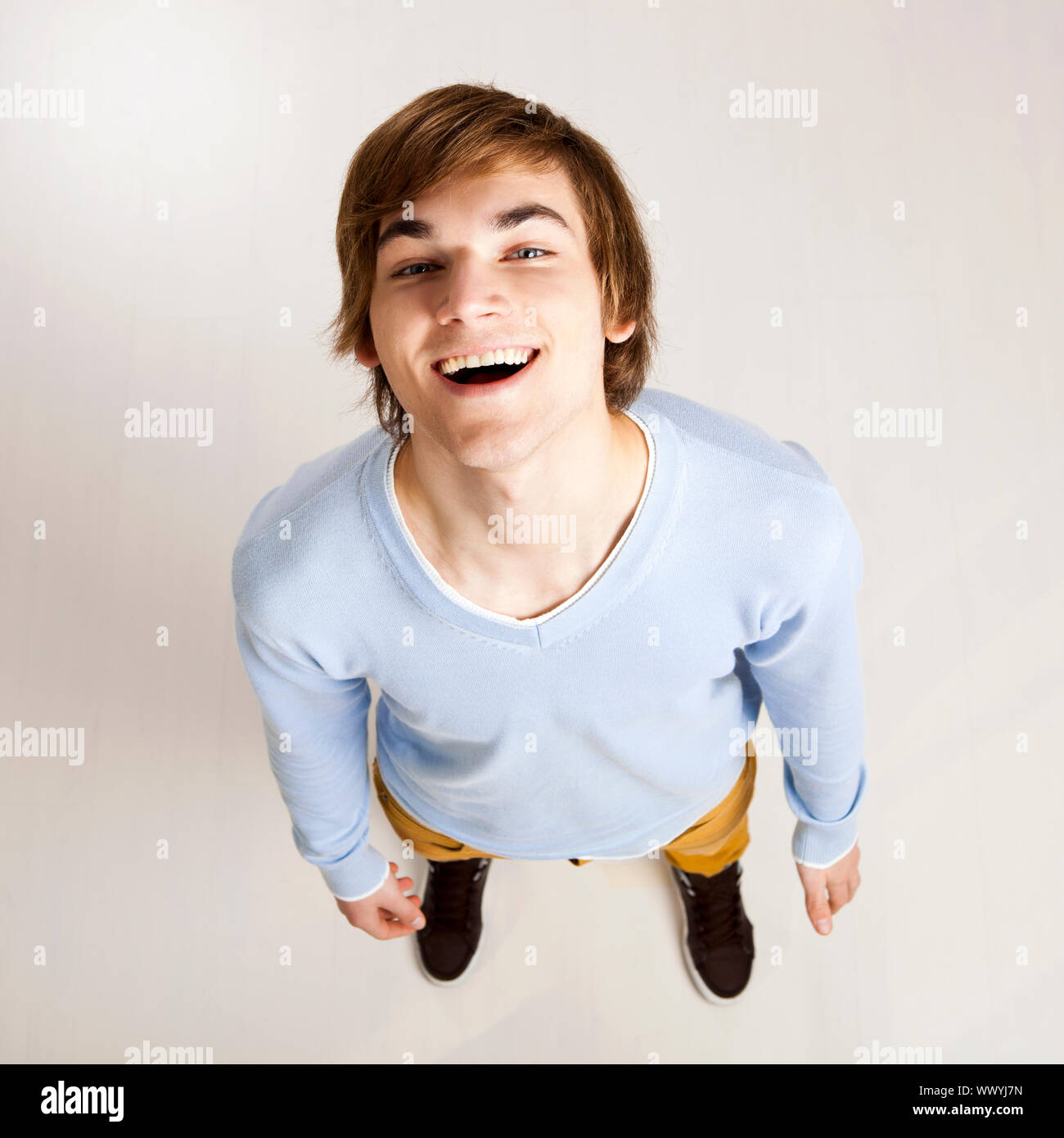 Portrait of a handsome young man looking up and laughing Stock Photo ...