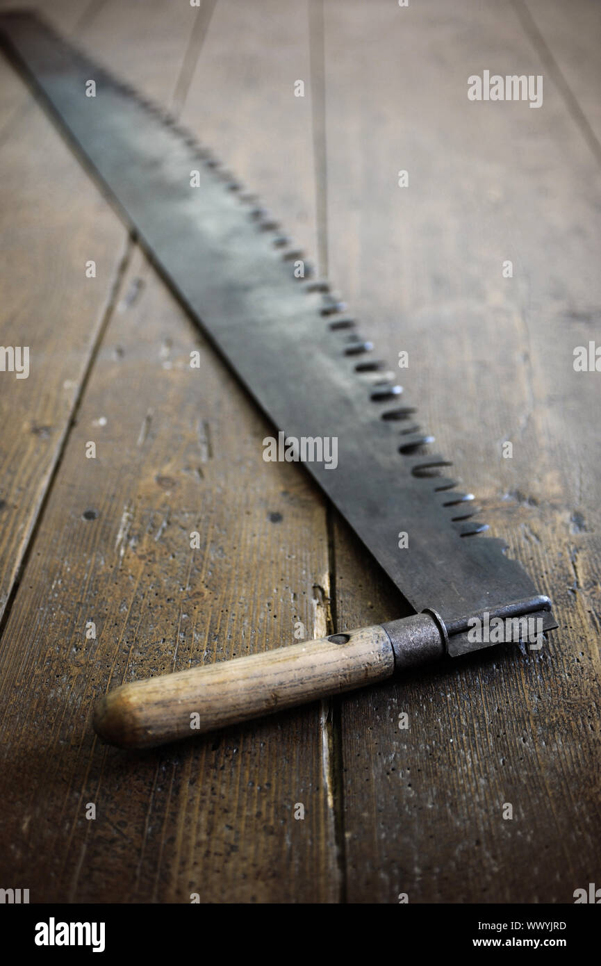 a old saw of a woodcutter is leaning against the old wood floor Stock ...