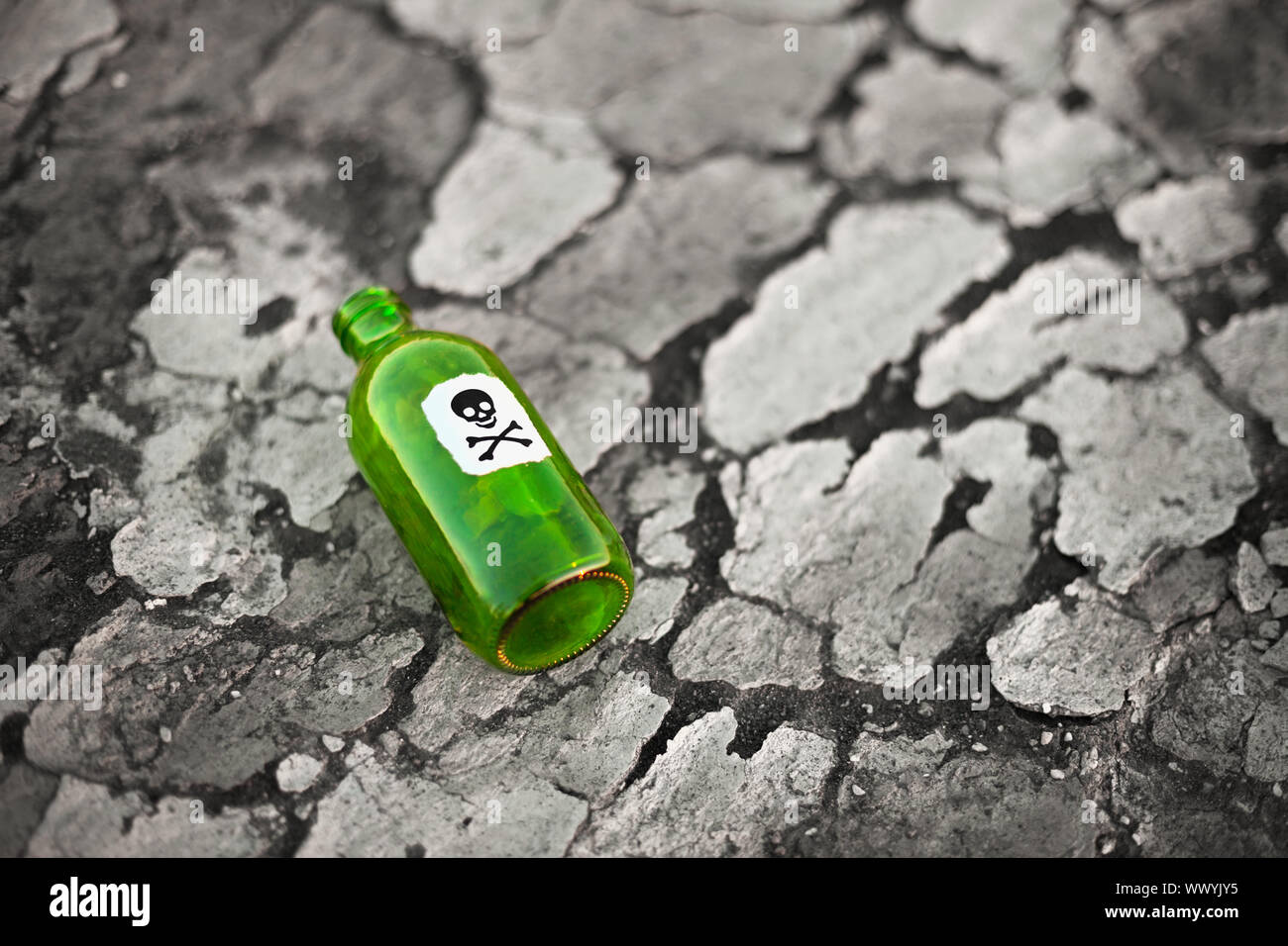 Bottle with the poison lying on poisoned ground Stock Photo - Alamy