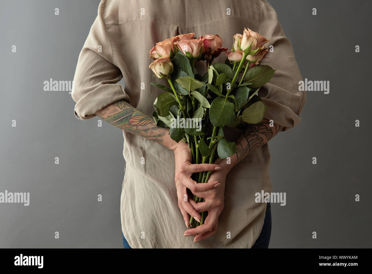 A woman is holding a beautiful roses cappuccino behind her rear Stock ...