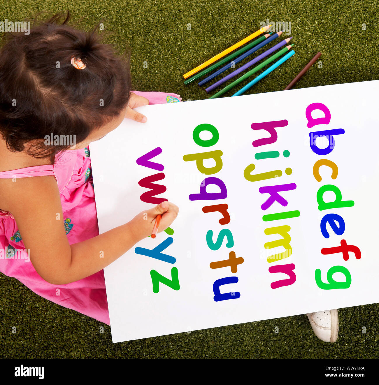 Girl Writing Alphabet Shows A Kid Learning Stock Photo - Alamy